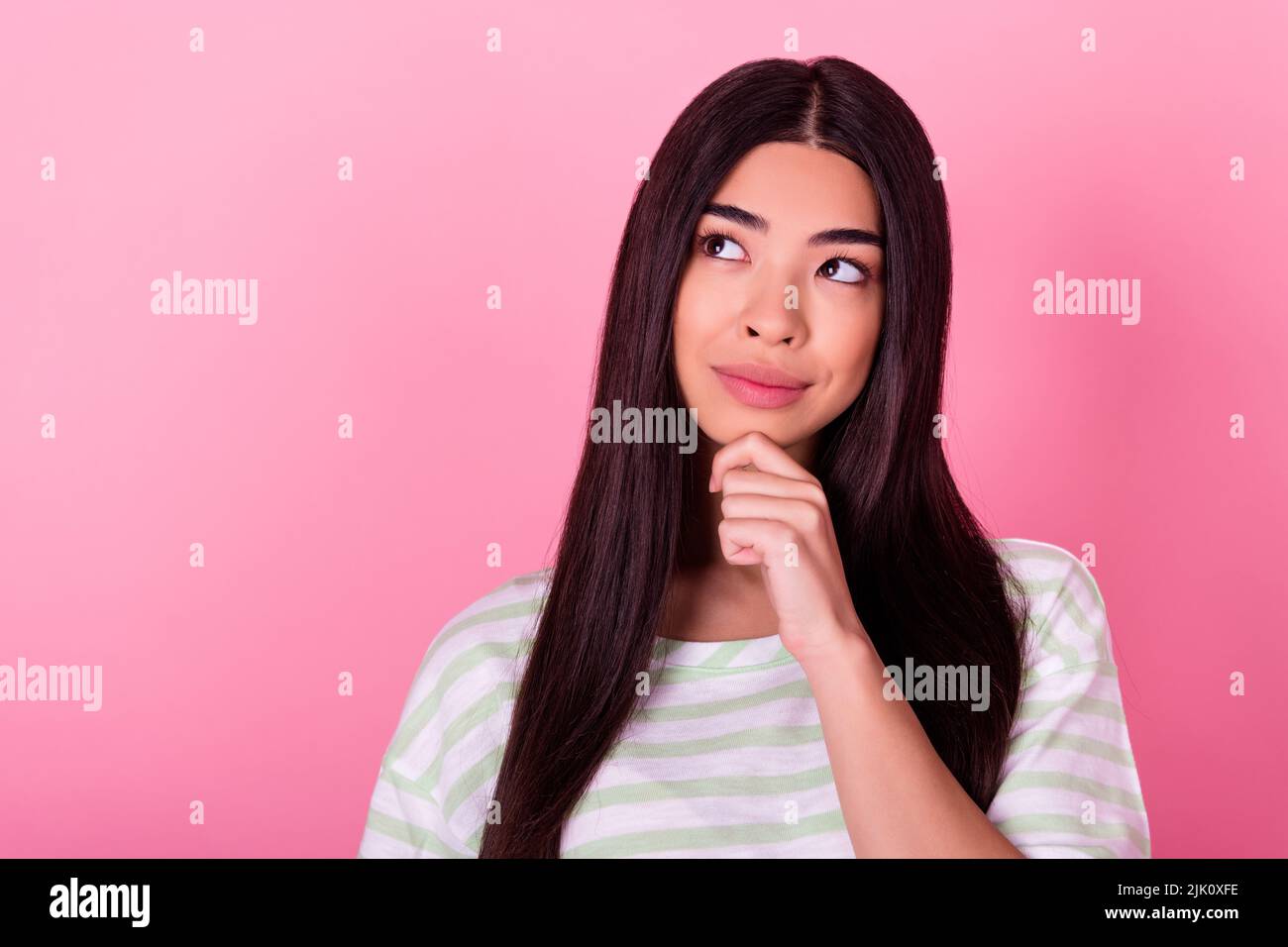 Photo of nice positive thai girl hand touch chin look interested empty ...