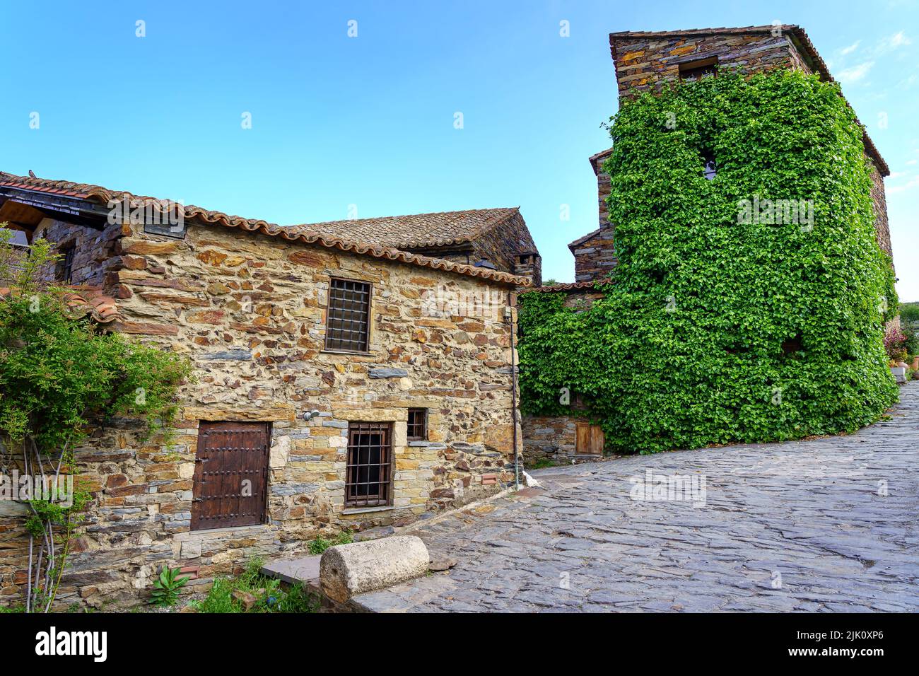 old houses with ivy covered facades and blue summer sky. Patones de ...