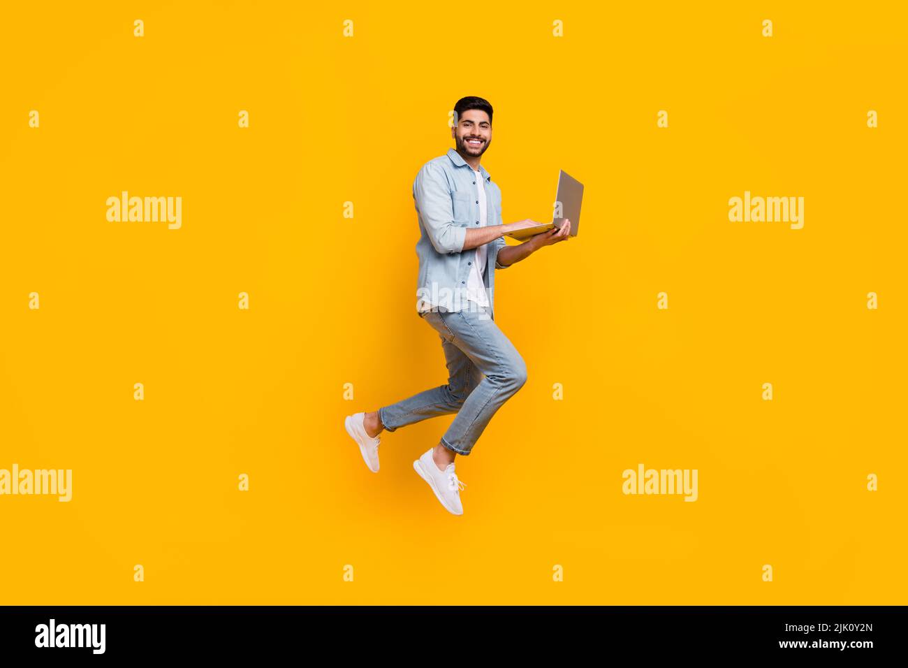 Full length photo of cheerful skilled man guy jump up use device laptop ...