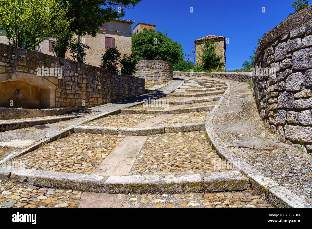Old Romanesque church with its access of old stone stairs and its bell tower. Sepulveda ...