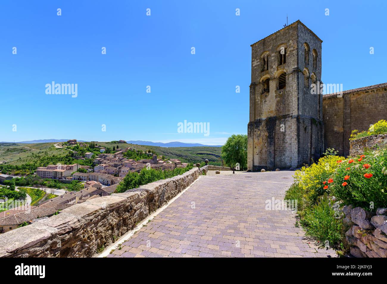 Old Romanesque church with its bell tower and sunny blue sky. Sepulveda ...