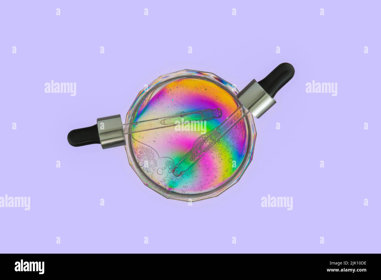 Serum dropper in a petri dish on a plastic film rainbow colored by ...