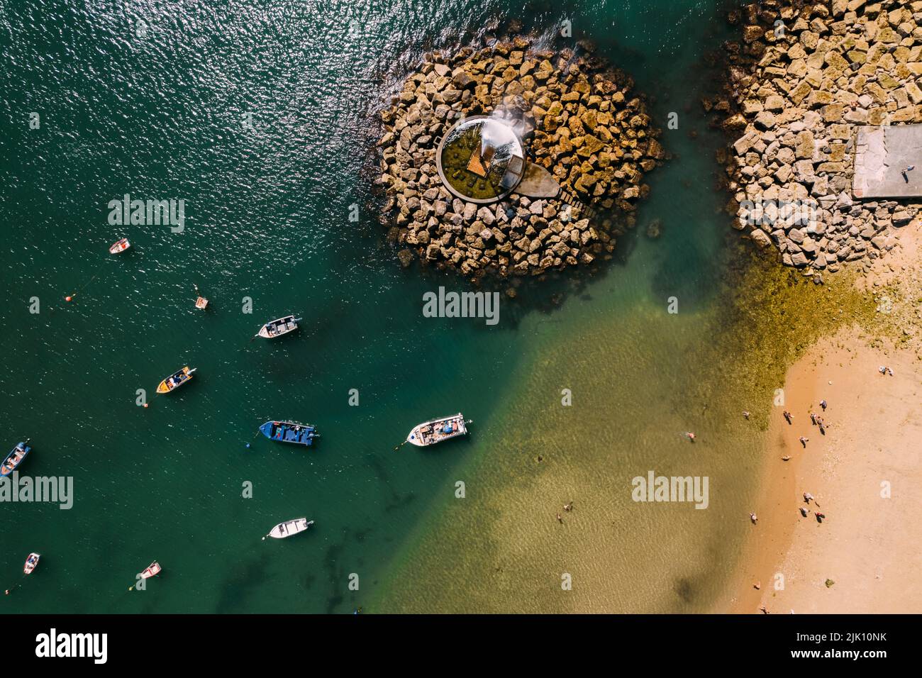 Top down aerial biew of people at Praia Velha which means Old Beach at ...