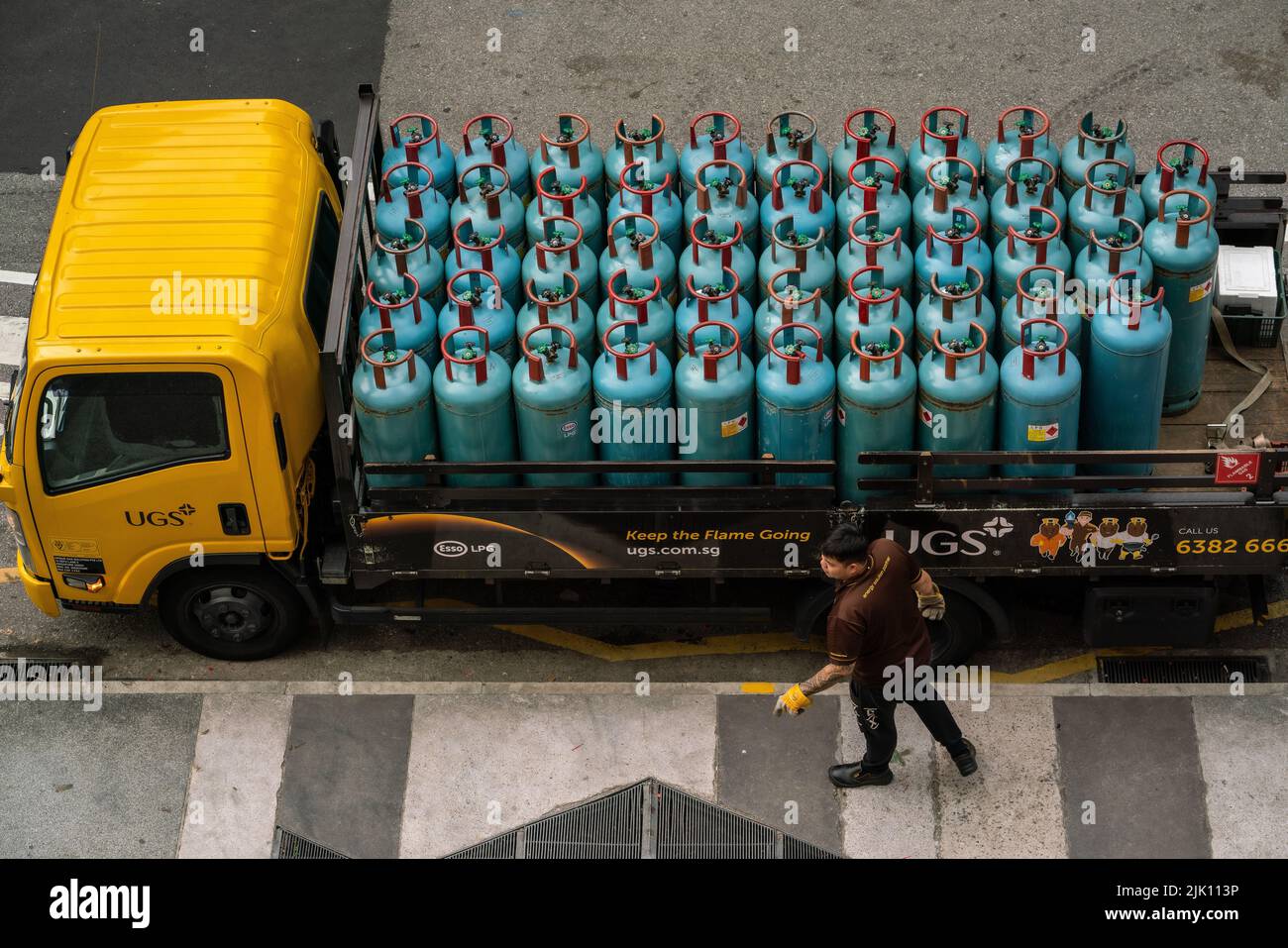 A worker loading gas cylinders at Queen Street, Bugis, Singapore ...