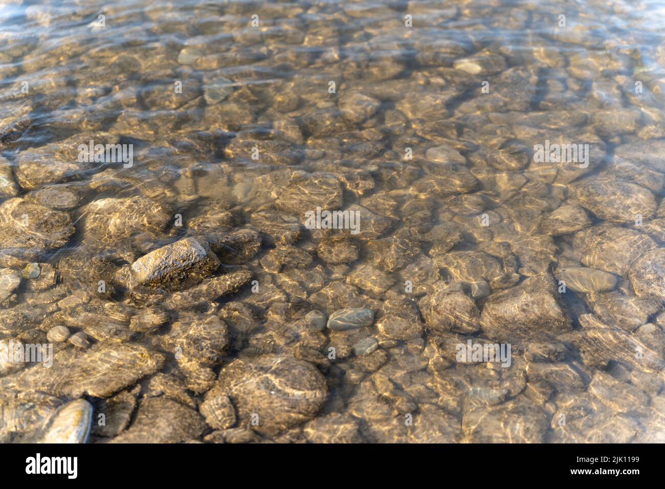 Clear transparent water of a lake with rocks on the bottom Stock Photo ...