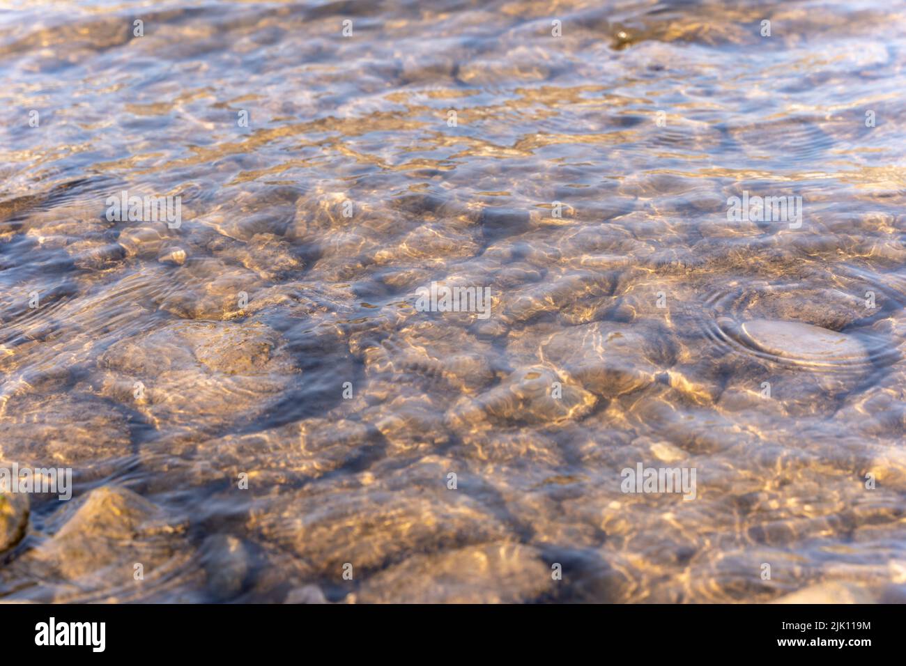 Clear transparent water of a lake with stones on the bottom Stock Photo ...