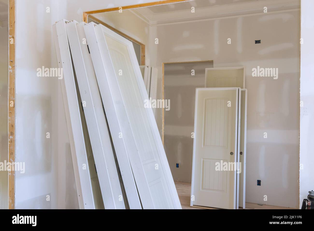 The installation of white stacker doors in the interior of a new home ...
