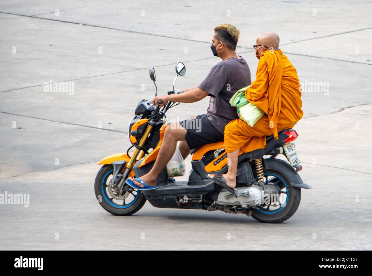 SAMUT PRAKAN, THAILAND, APR 19 2022, A man rides a motorcycle with a ...