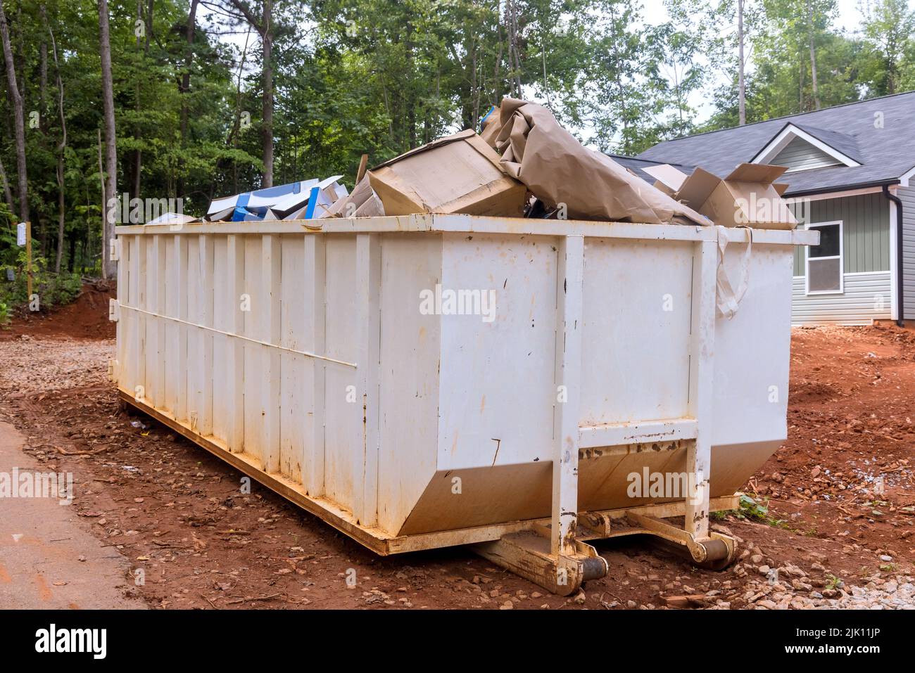 A rubbish removal container on of a house underneath an industrial ...