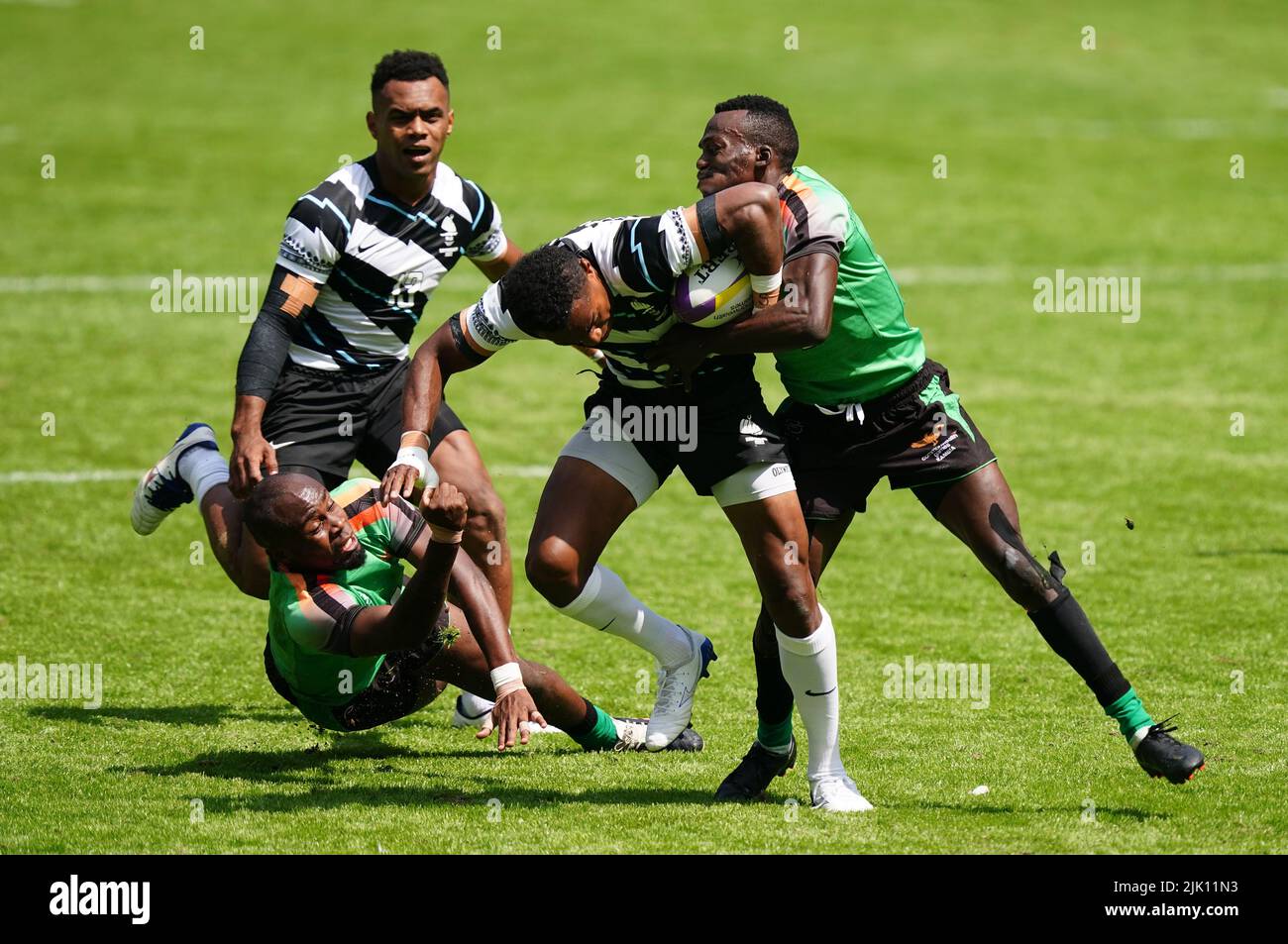 Fiji's Sireli Maqala (centre) is tackled by Zambia's Melvin Banda (left ...