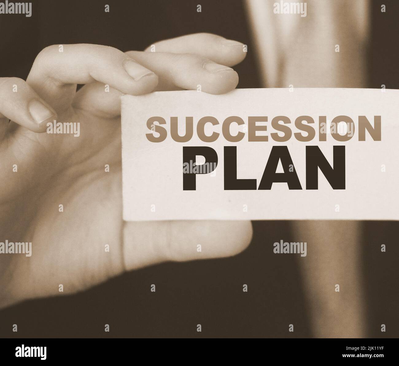 Succession Plan words on a card in hand of businessman. Business profit ...