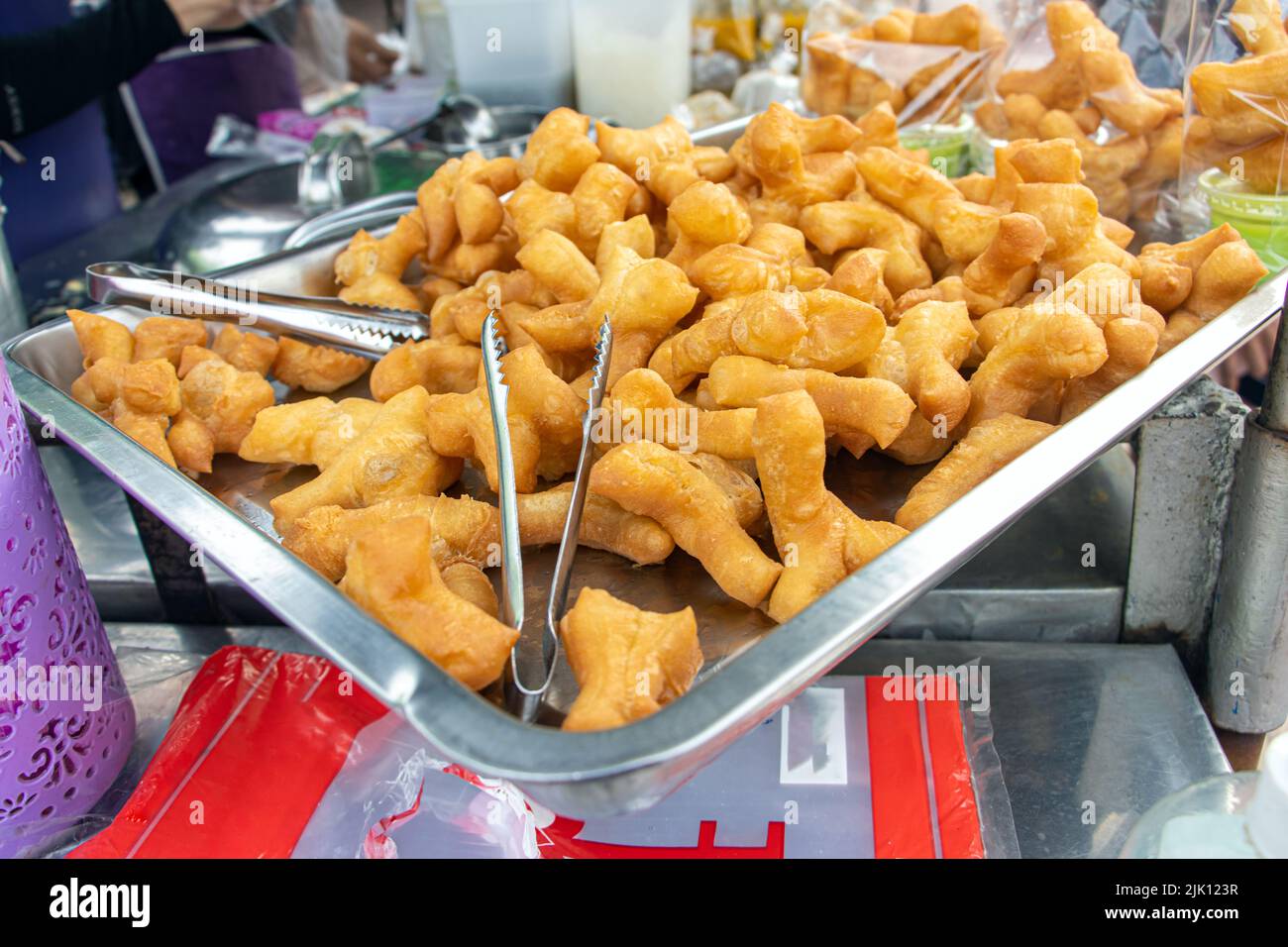 The offer of a deep-fried dough stick at Thai market, close up Stock ...