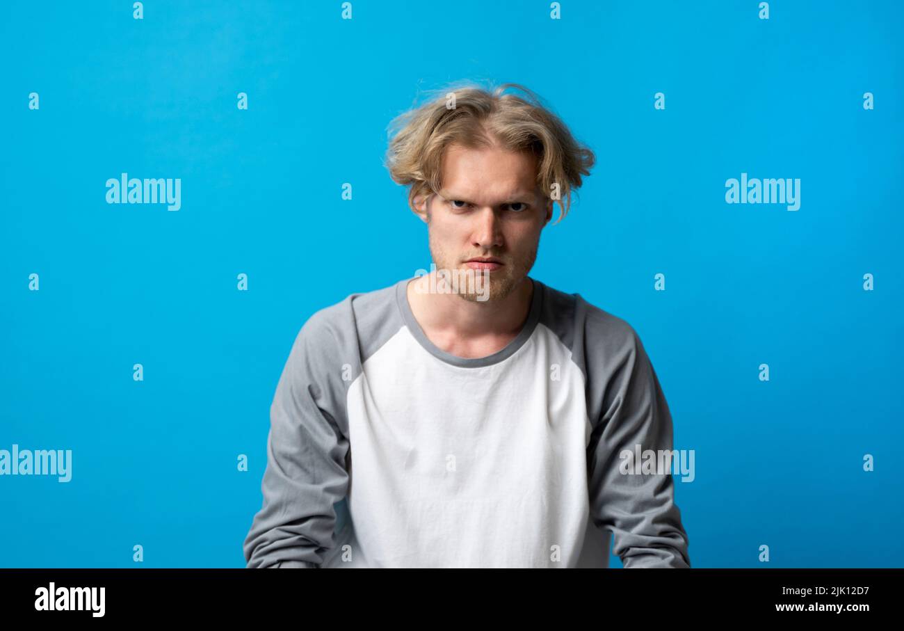 Portrait of an upset unsatisfied man standing with arms and a backs and ...
