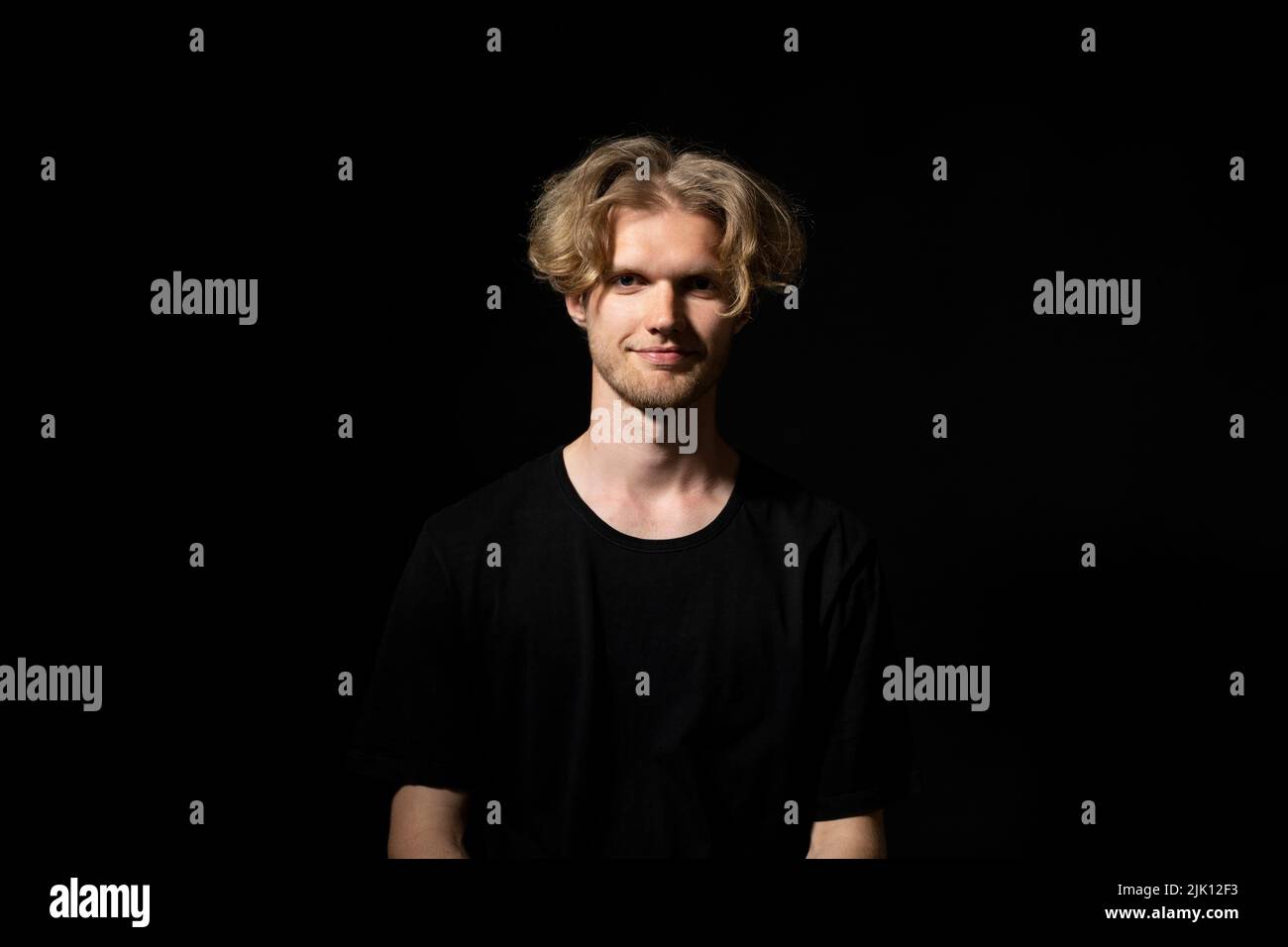 Attractive man with long hair being very glad smiling with broad smile ...
