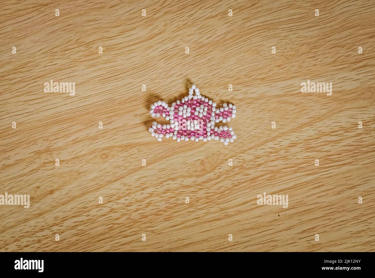 Handmade pink and white, seed bead skull and cross bones trinket charm ...