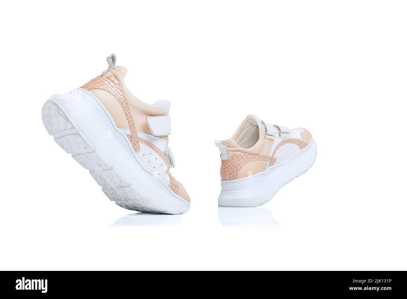 Casual, peach colored sneakers, shoes isolated over white studio ...