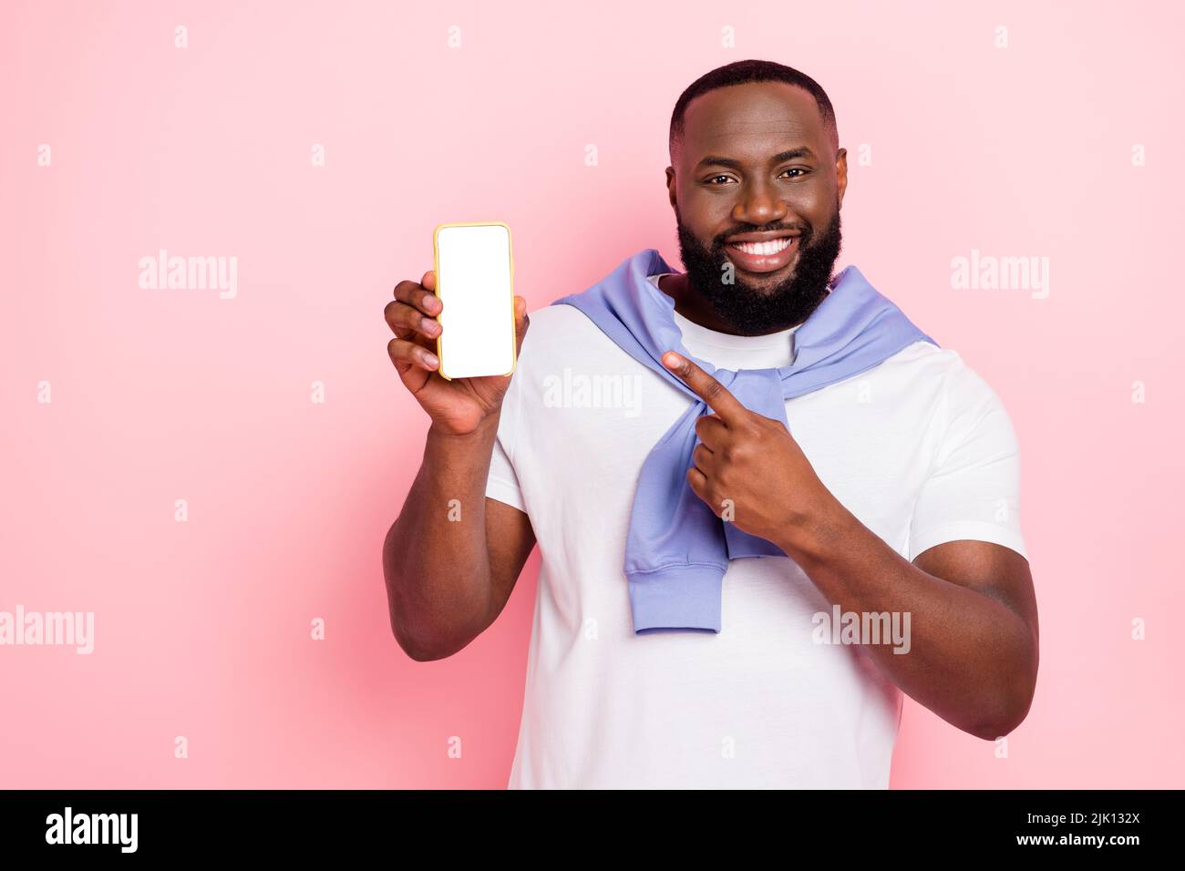 Photo of young handsome man promote online shop store show phone ...
