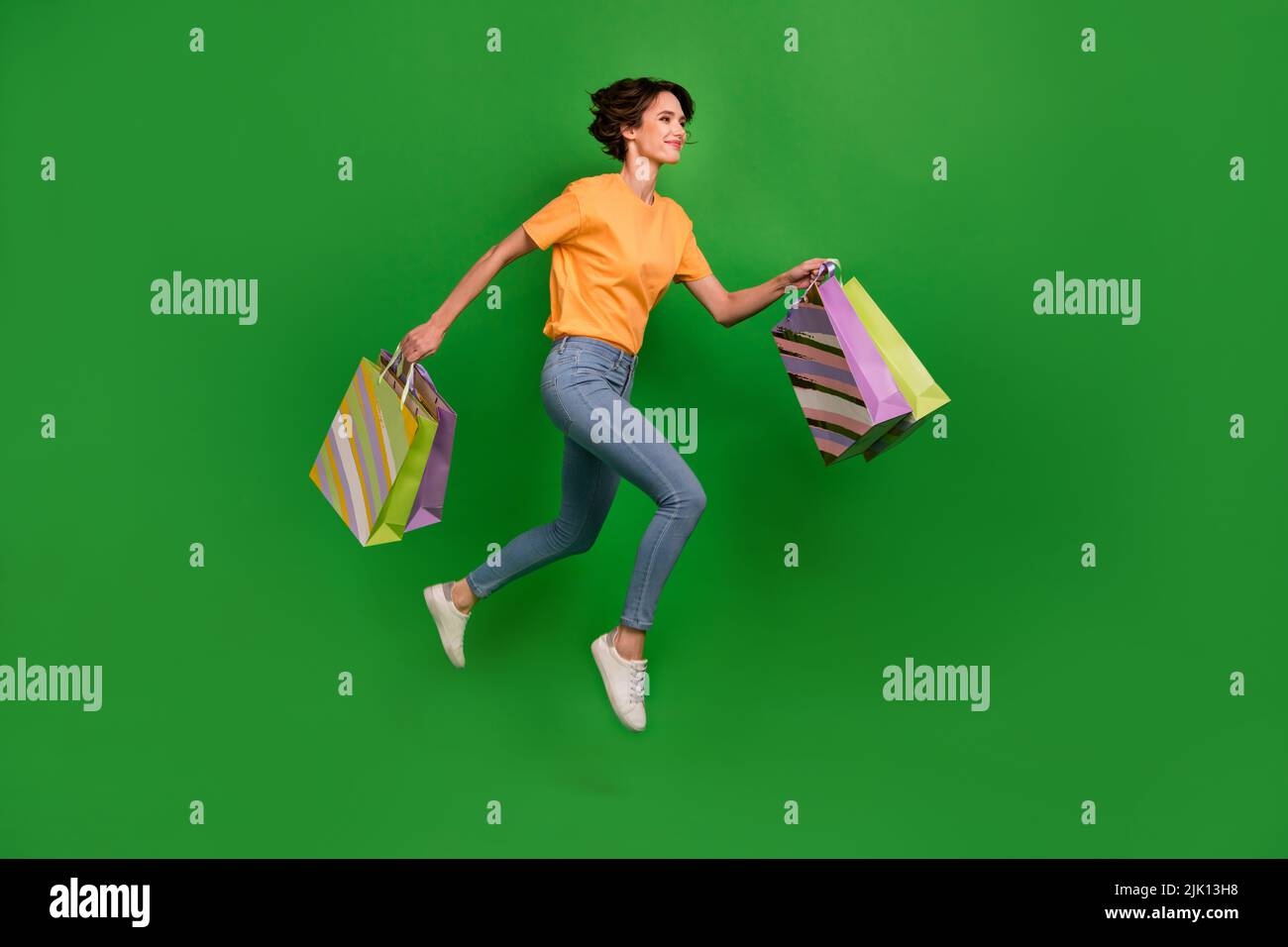 Full body profile portrait of crazy energetic lady hold packages jump ...