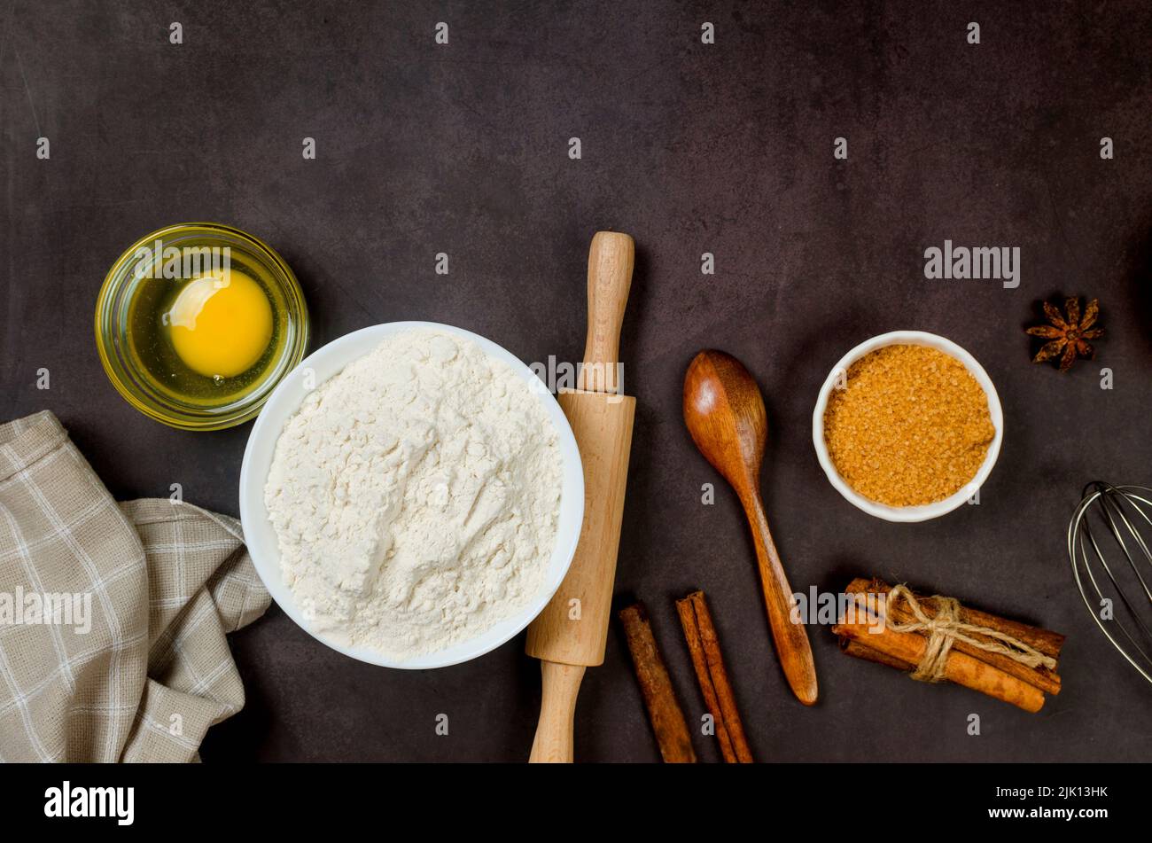 Top view of ingredients bakery making on dark old table. Flour, eggs ...