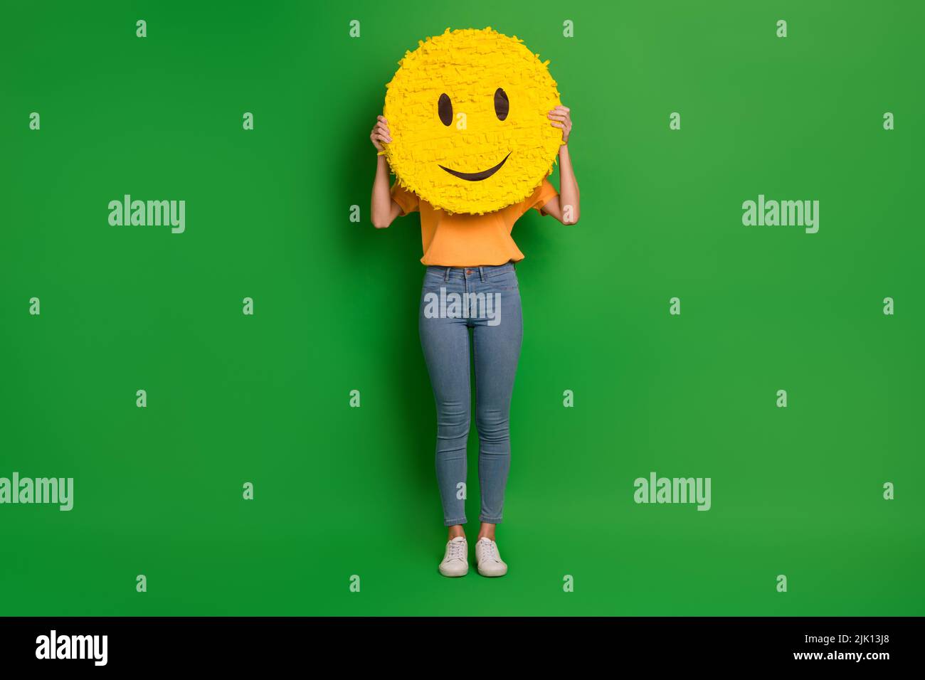 Full body photo of excited carefree person hands hold large smile emoji ...