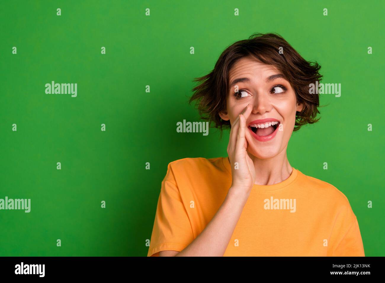 Photo of excited shiny young lady wear orange outfit arm lips looking ...
