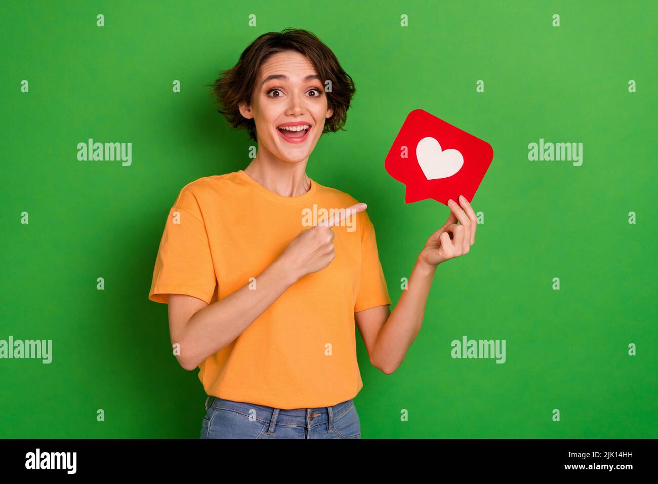 Photo of funny excited young woman dressed orange t-shirt showing ...