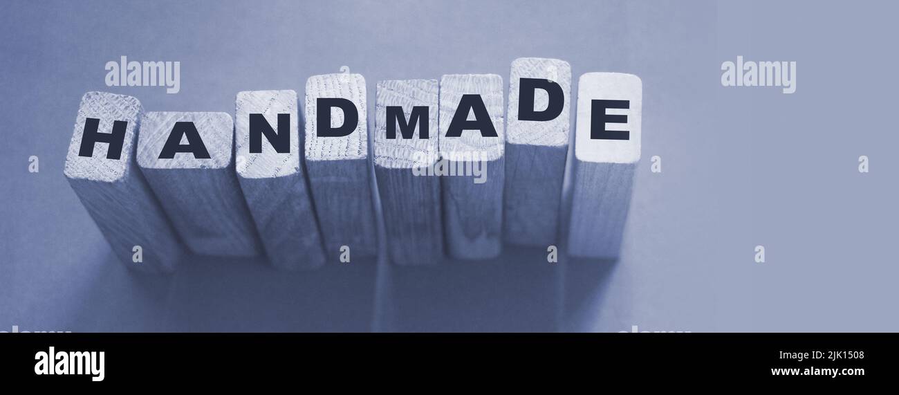 Handmade word on wooden blocks, light blue background. Hobby handmade ...