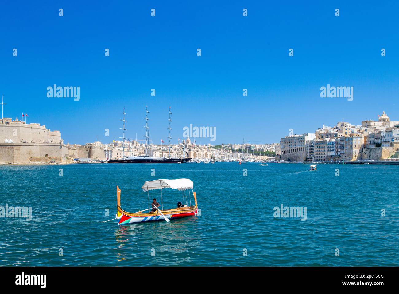 Traditional ferry boat crossing the Grand Harbour, with the Maltese ...