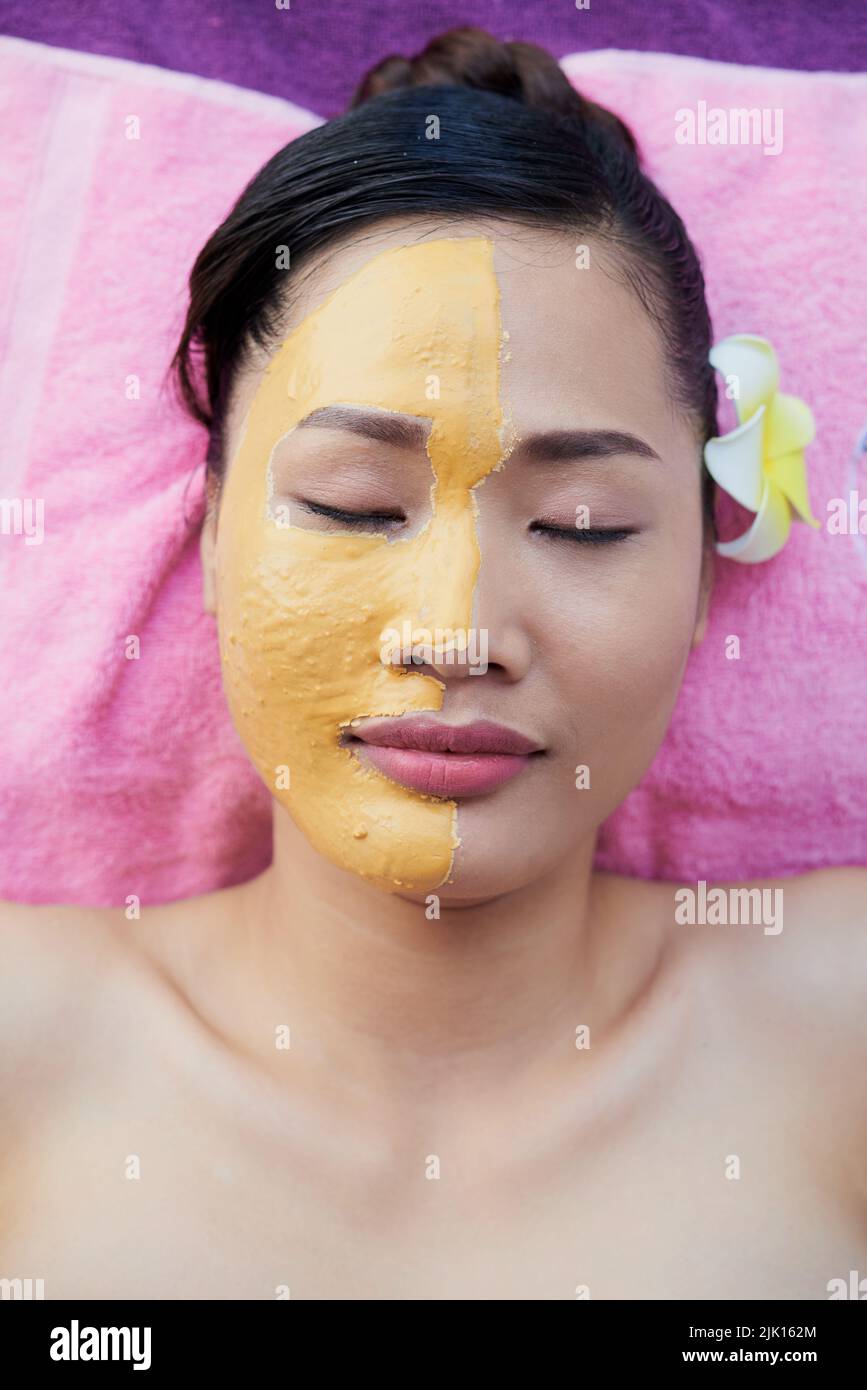 Asian young woman with half of her face covered with mask Stock Photo ...