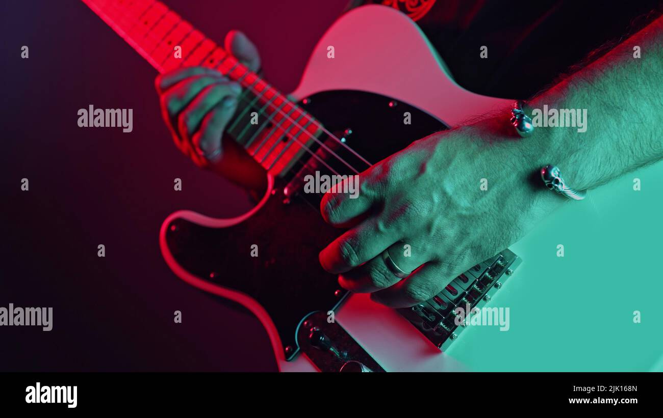Rock guitarist man on smoky stage masterfully playing electrical guitar ...