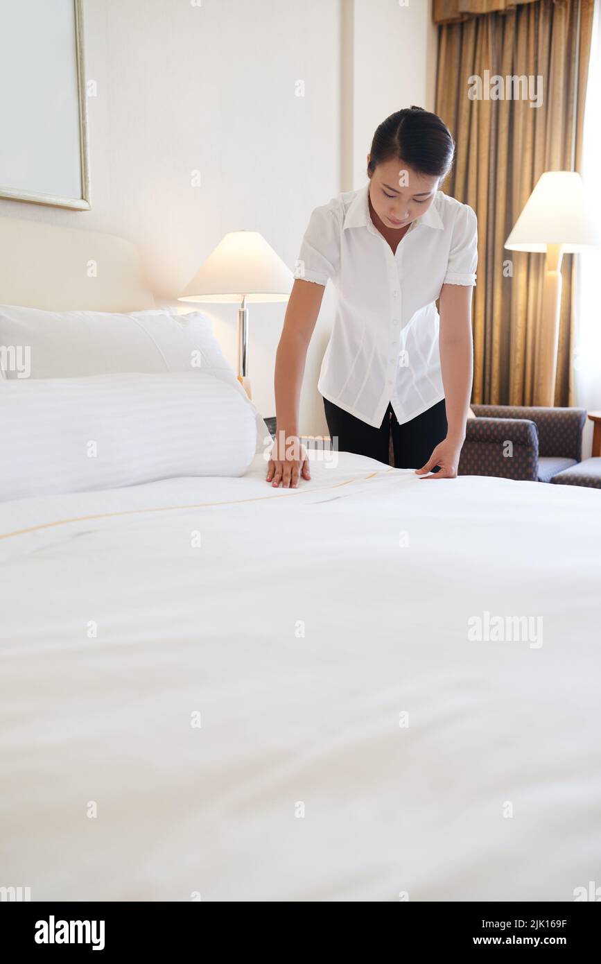 Asian young woman working as maid in the hotel Stock Photo - Alamy