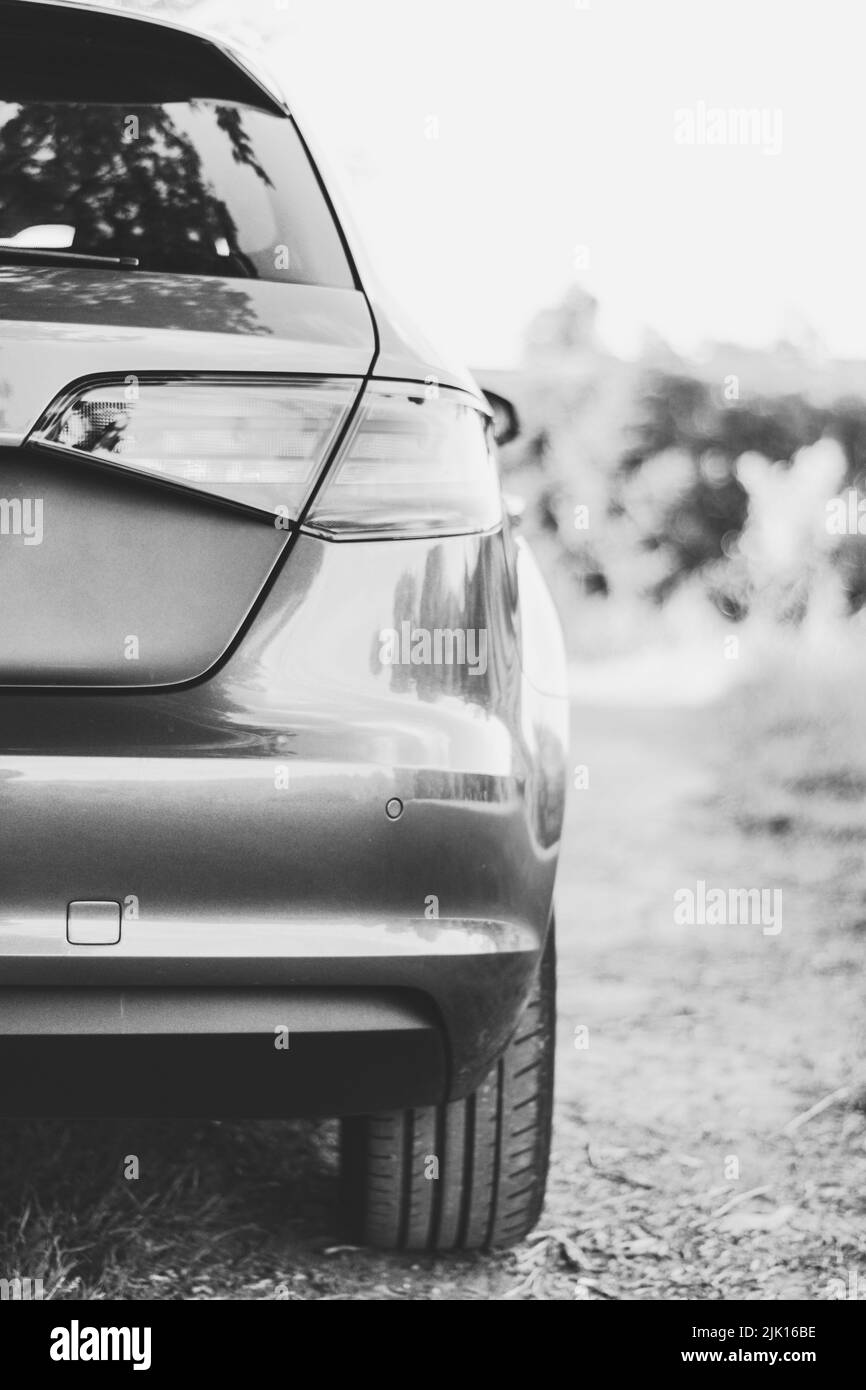 A vertical grayscale shot of the rear part of a car Stock Photo - Alamy