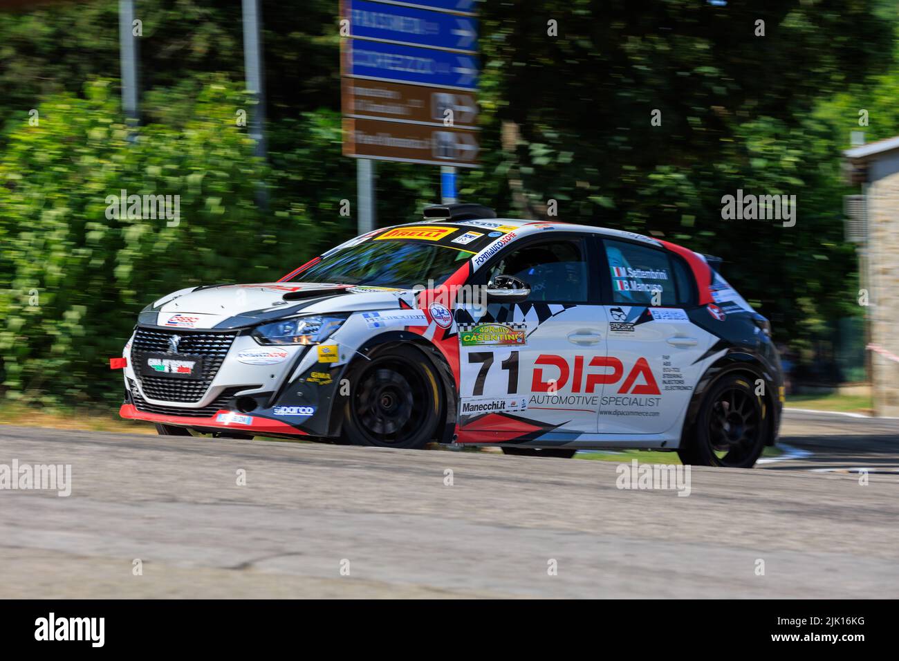 A white Rally car 42 Rally Internazionale Casentino on a road with blur ...