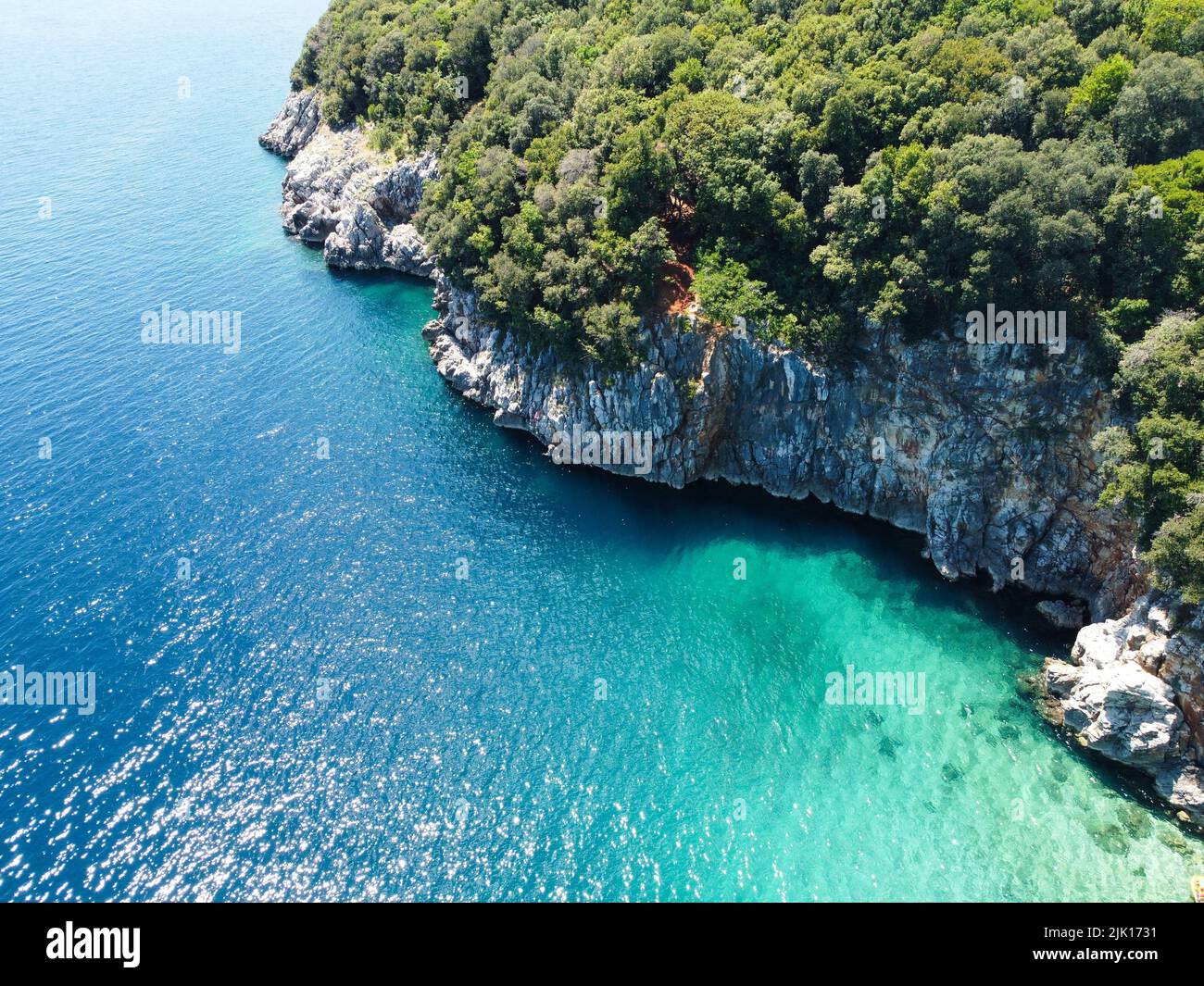 An aerial view of green rocky cliffs by the sea in Moscenice, Croatia ...