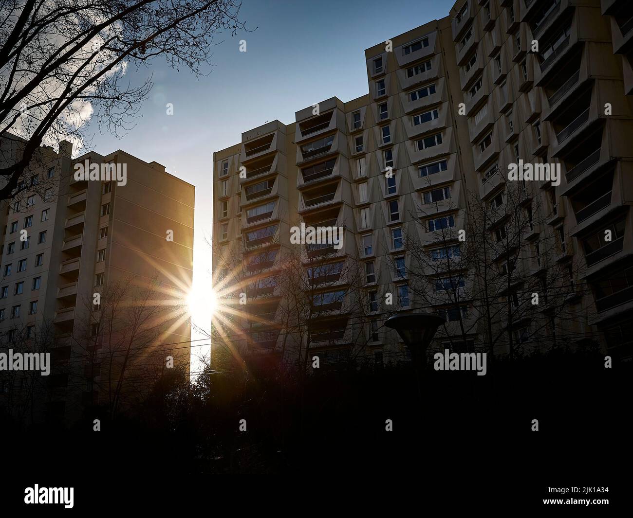 The sun shining between residential buildings Stock Photo - Alamy