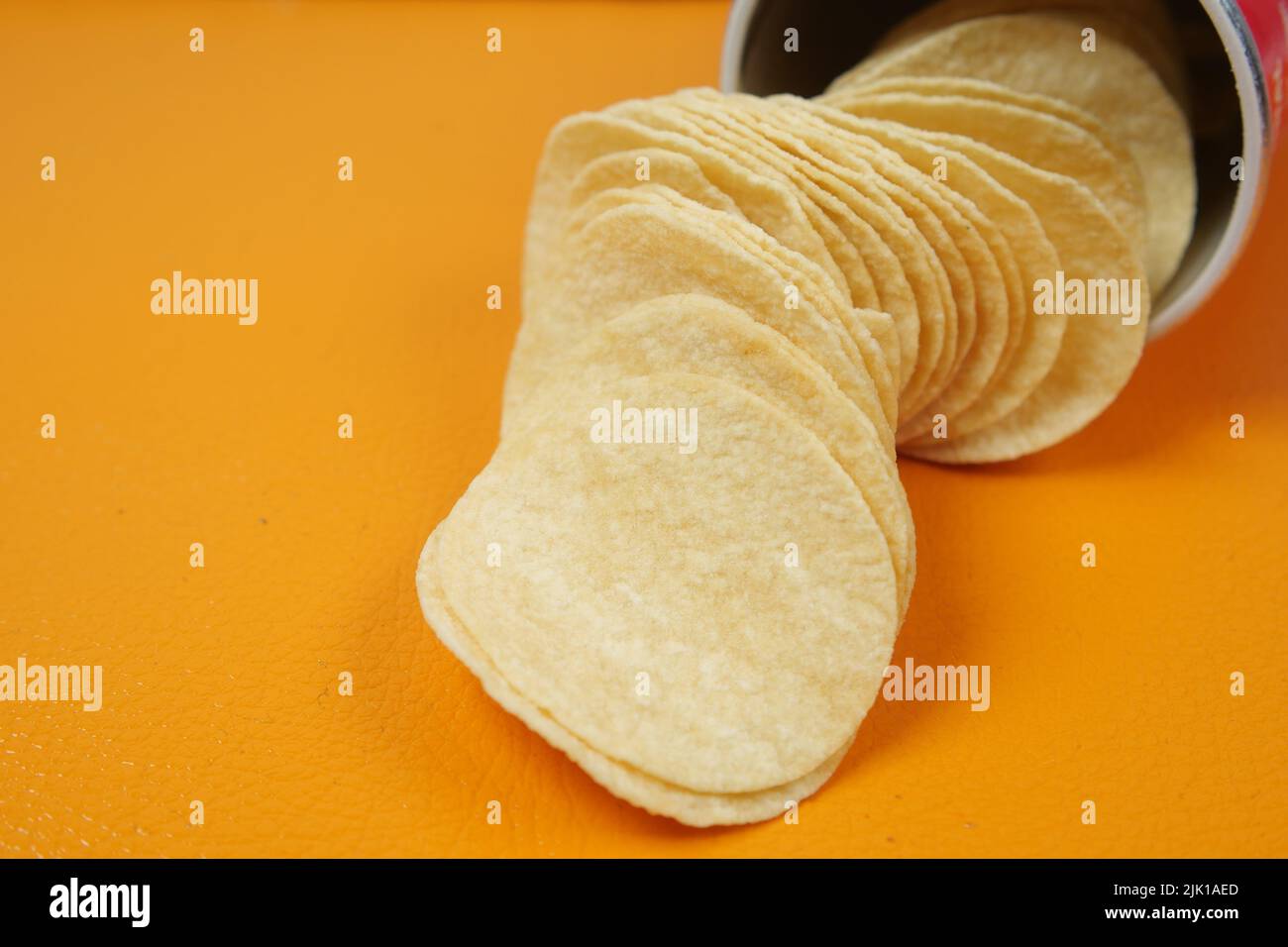 potato chips spilling form a packet on table Stock Photo - Alamy