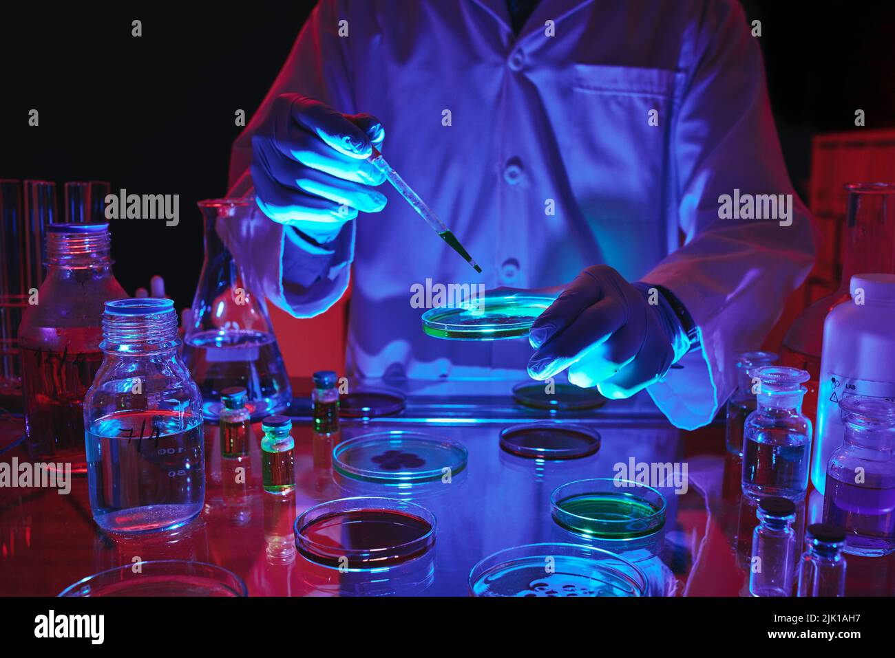 CLose-up image of laboratory worker adding reagent in petri dish Stock ...