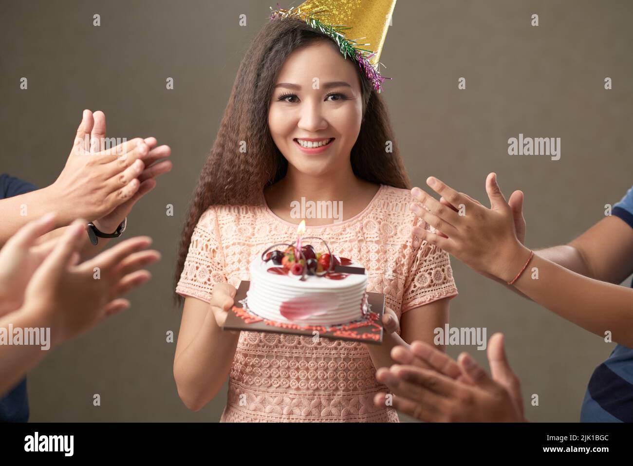 People clapping to young smiling woman with birthday cake Stock Photo ...