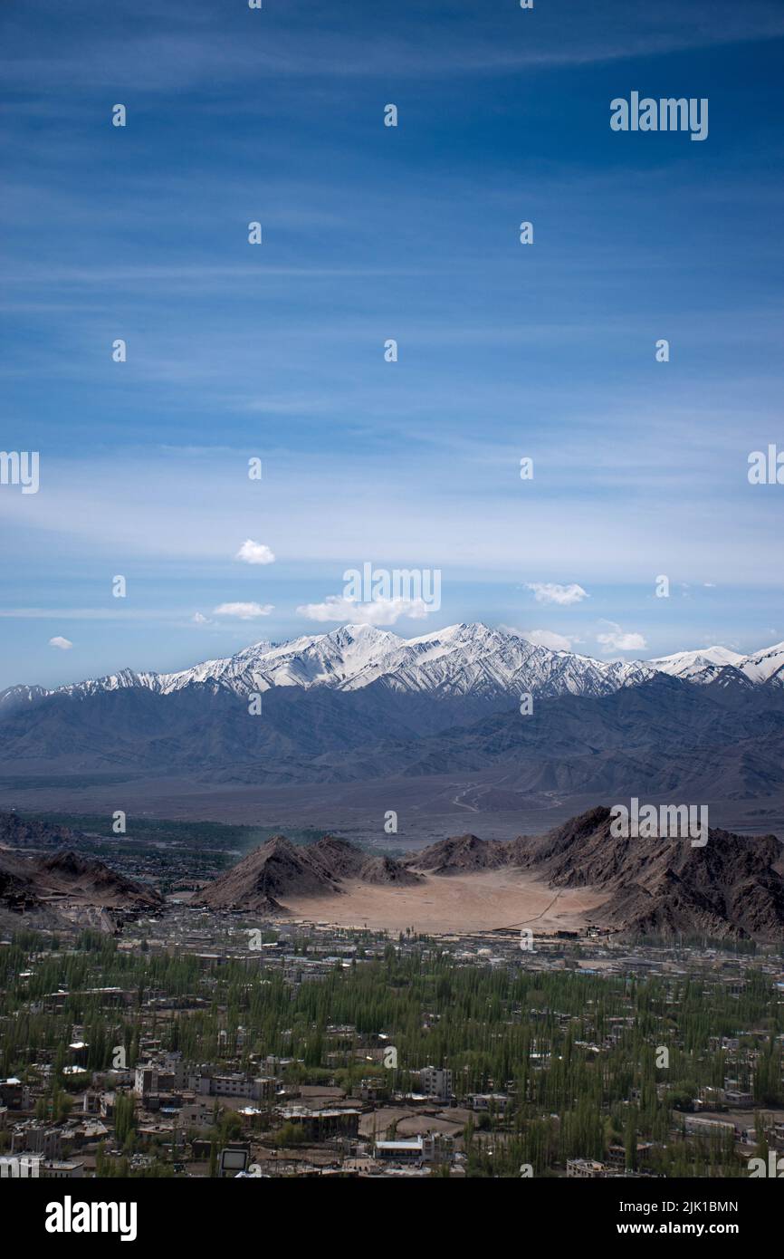 An aerial view of a landscape against a snowy mountain's peak in Ladakh ...