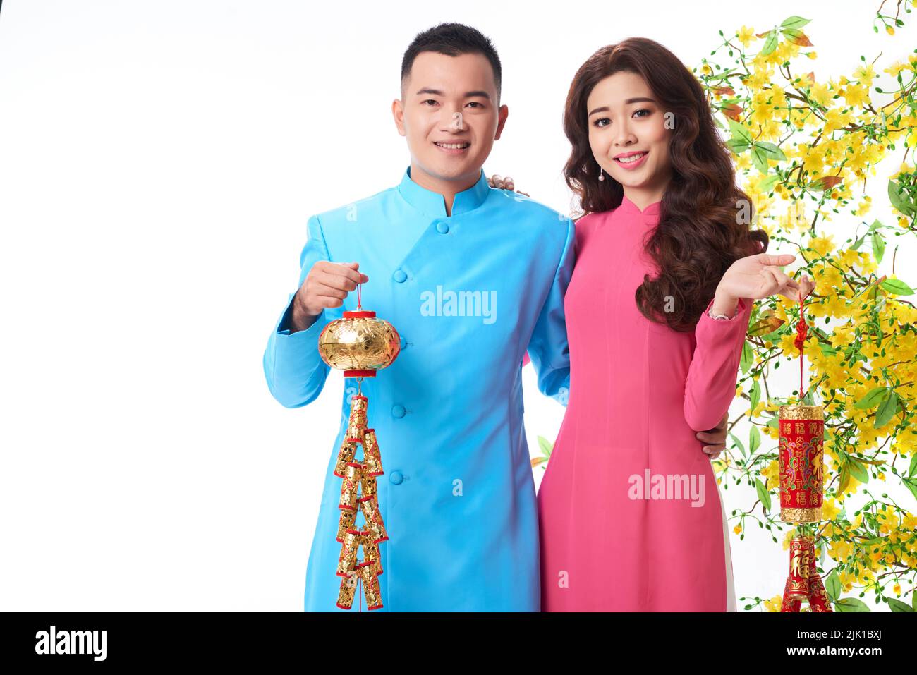 Smiling Vietnamese couple holding traditional spring festival ...