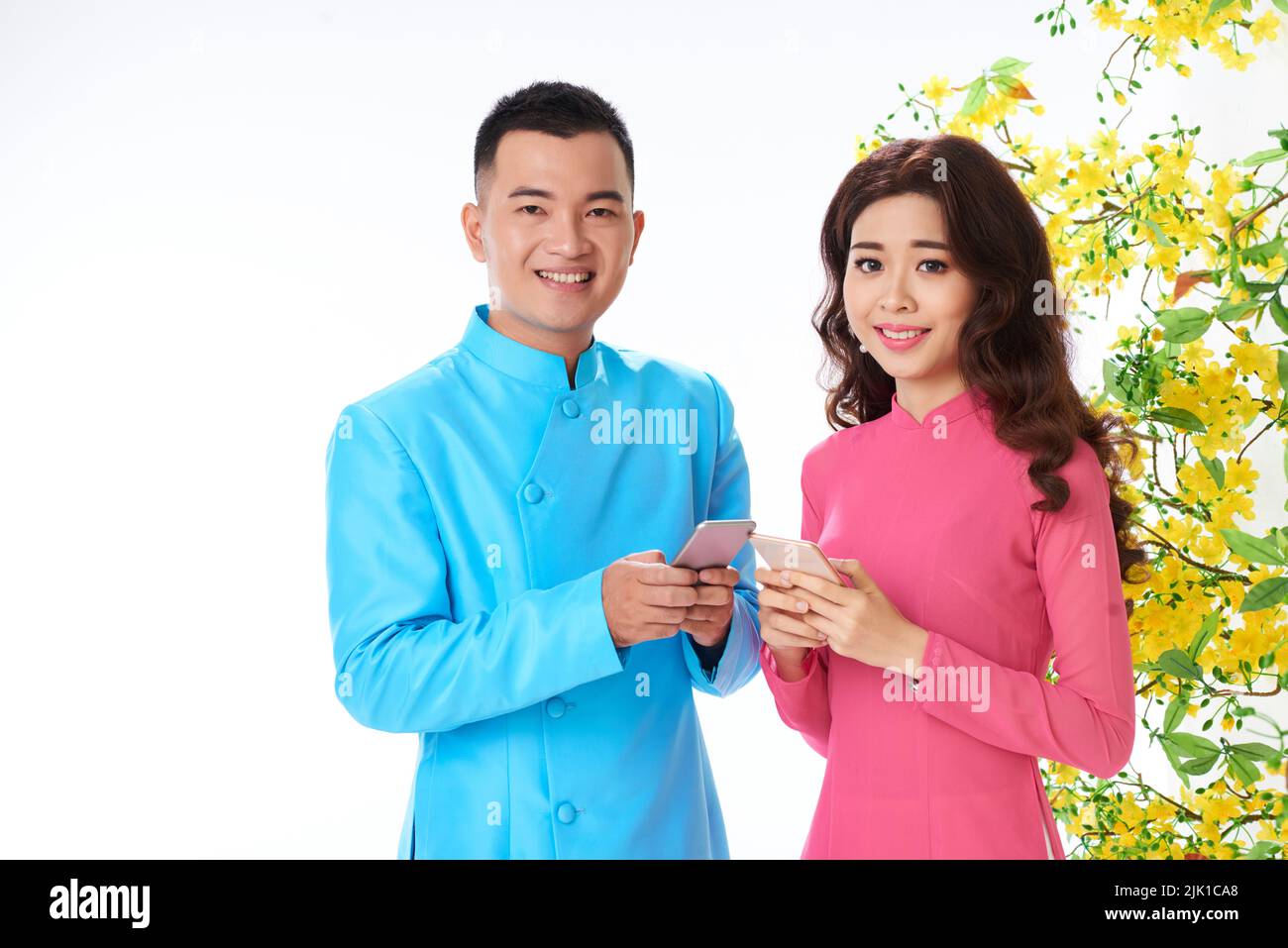 Asian couple sending messages to family and friends on Chinese New Year ...