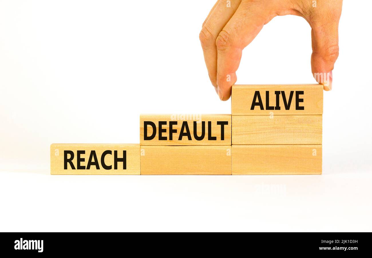 Reach default alive symbol. Concept words Reach default alive on wooden ...