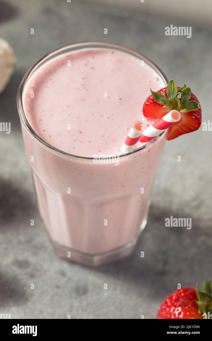 Cold Frozen Strawberry Milk Shake with a Straw Stock Photo - Alamy