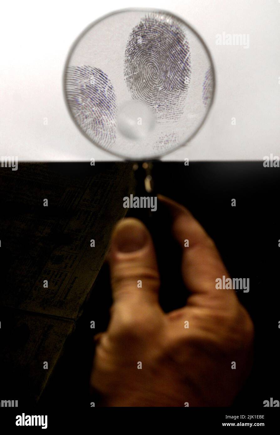 A forensic technician examines fingerprints from a crime scene Stock ...