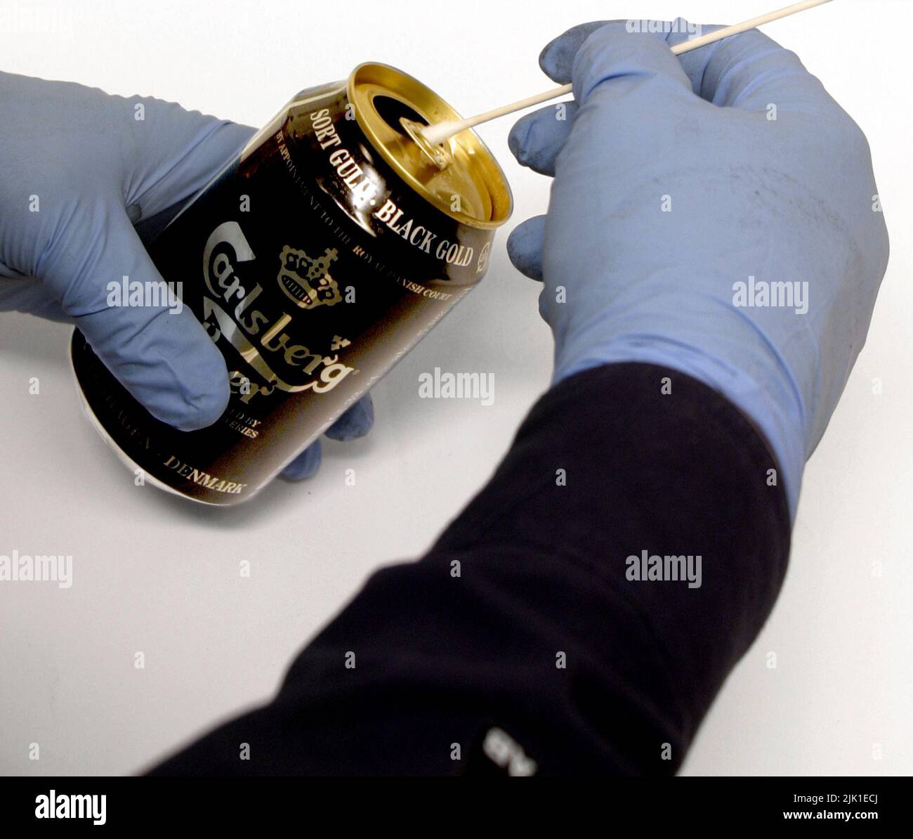 A forensic technician taking a DNA sample from a beer can Stock Photo ...