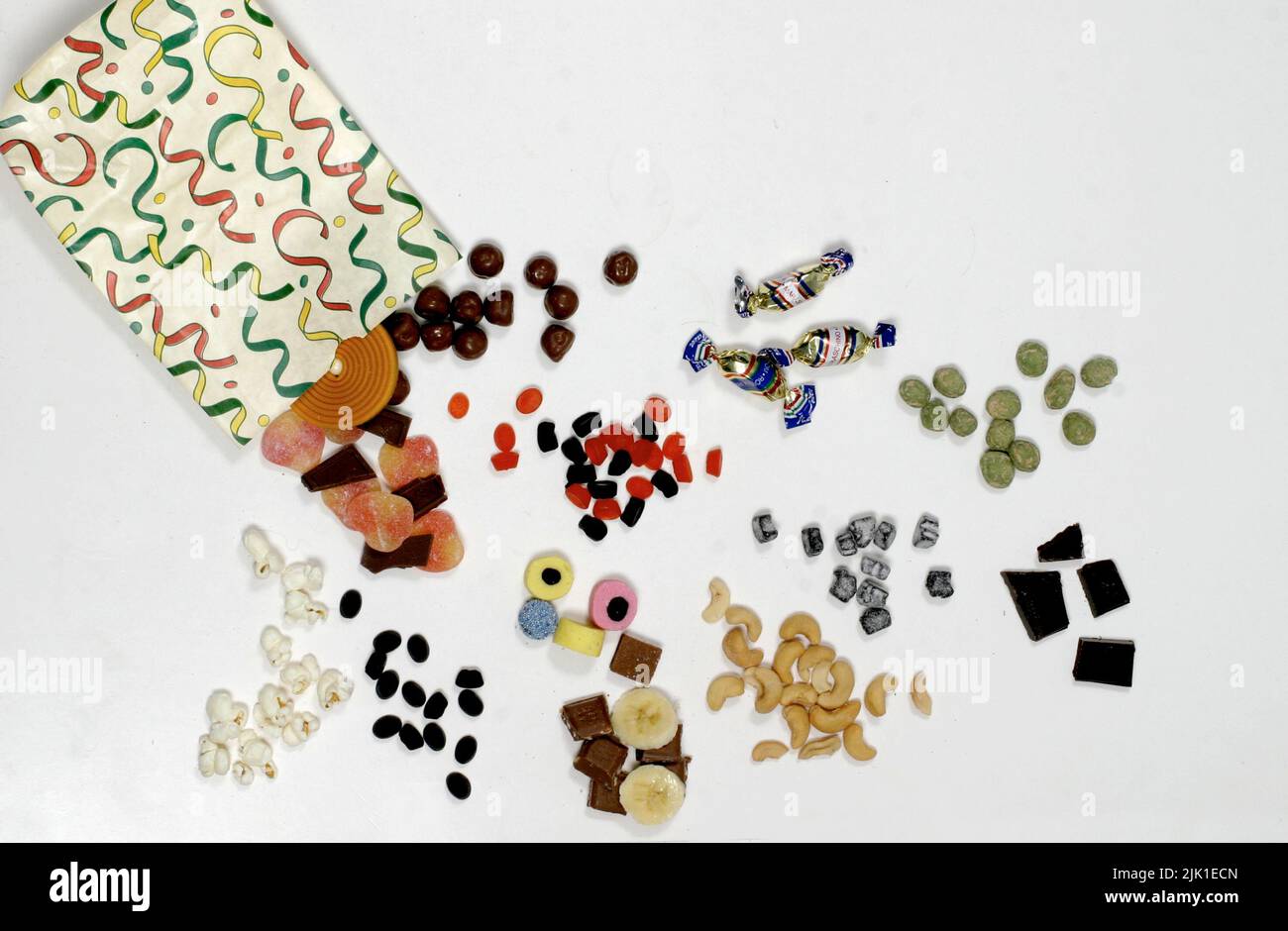 Different kinds of candy outside candy bag Stock Photo - Alamy