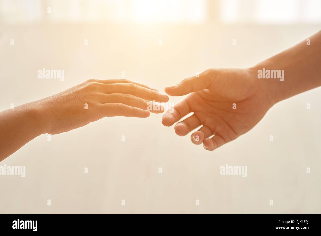 Hands of couple reaching for each other Stock Photo - Alamy