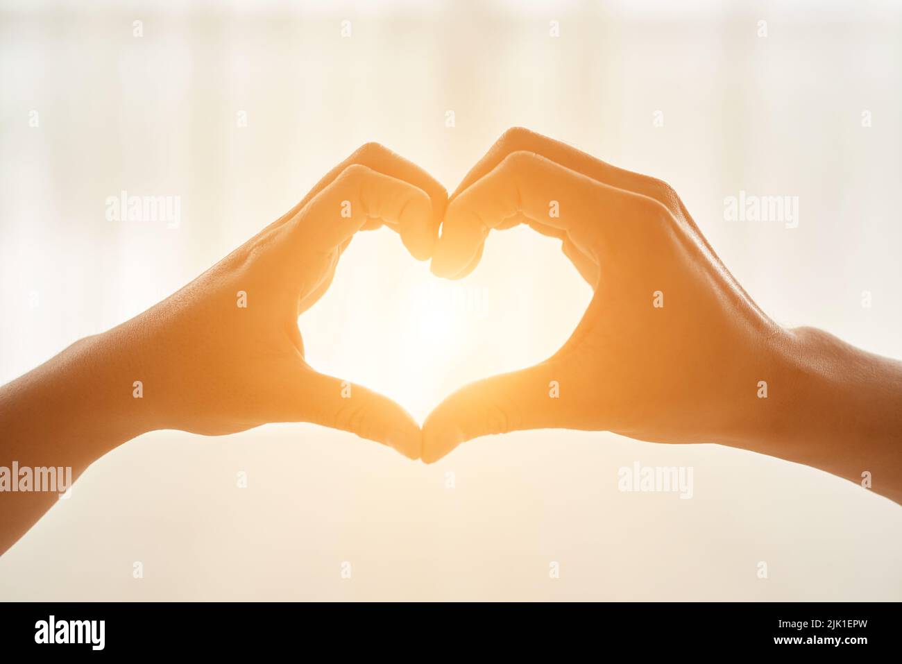 Couple making heart shape with their hands Stock Photo - Alamy