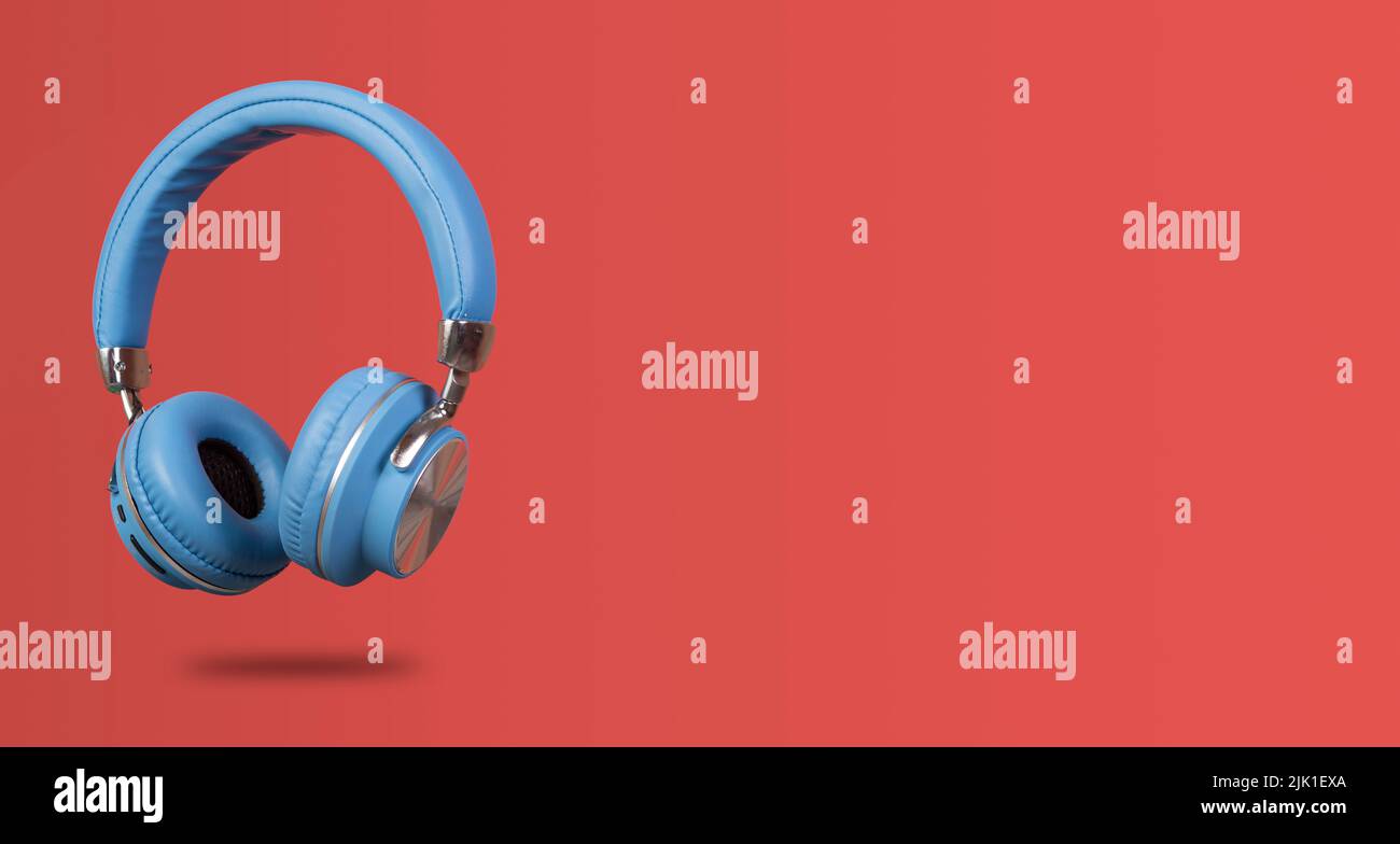 Side view of wireless headphone isolated on red banner background Stock ...