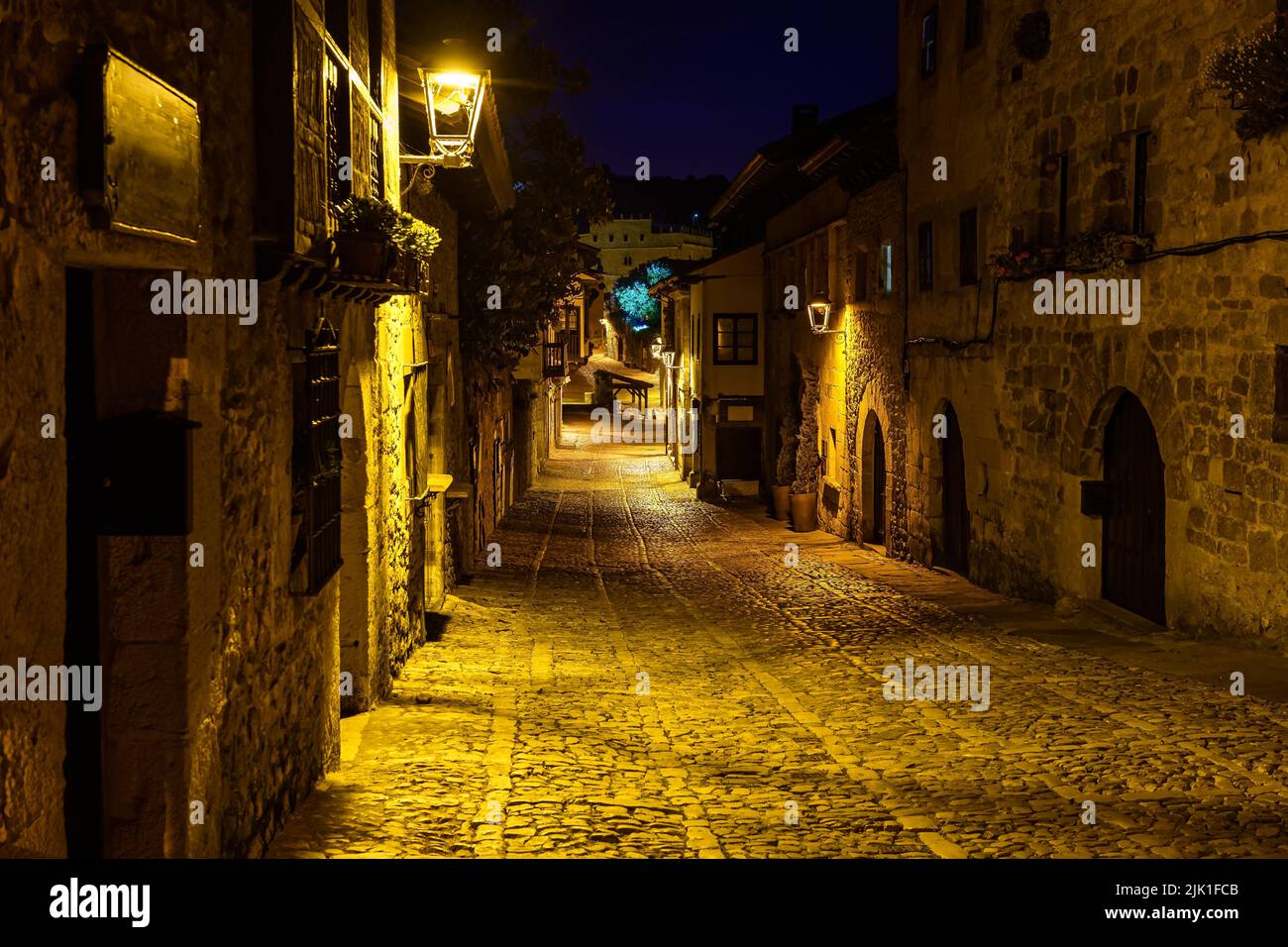 Main street of old stone town at night. Santillana del Mar, Santander ...